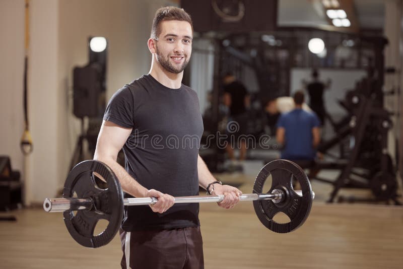 One Young Man Posing, Ordinary Average Looking, Holding Barbell with ...