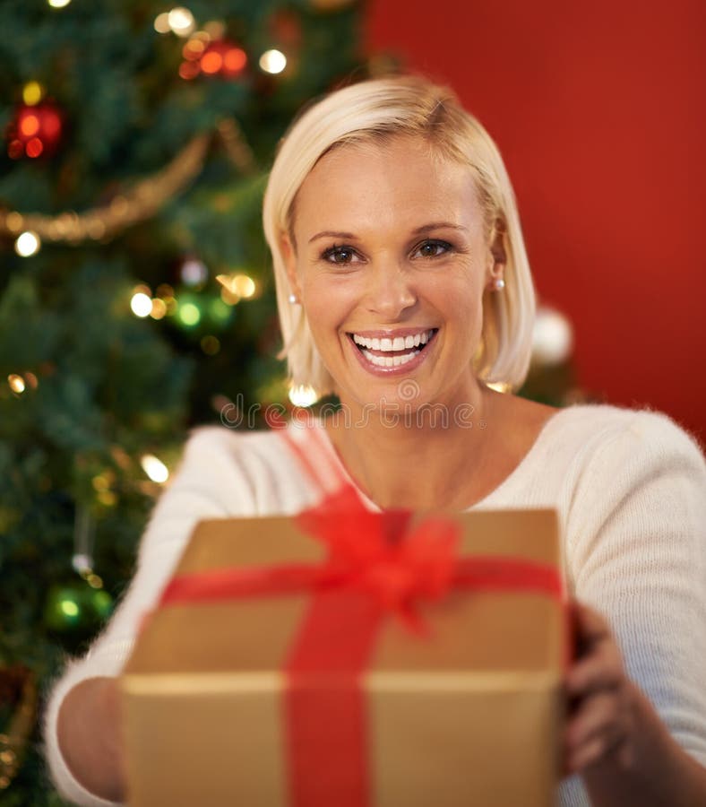 This Ones Yours. a Cheerful Young Woman Holding a Present. Stock Image ...