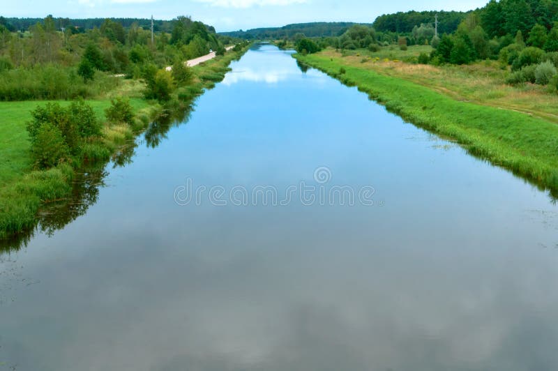 Smooth Channel with Reflection of the Sky, Long River with Overgrown ...