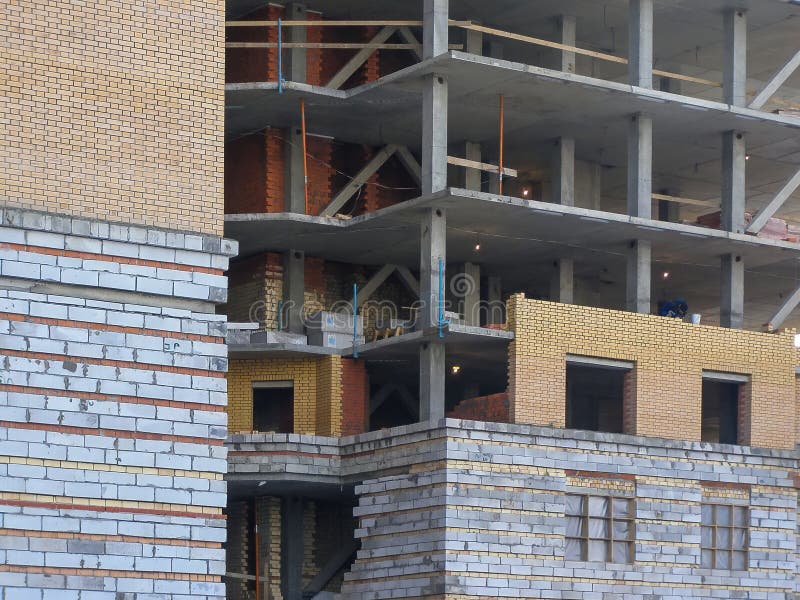 Two-story Building Under Construction Showcases Its Raw Concrete Framework, Pillars, and ...