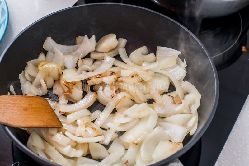 Onion fried in a pan stock photo. Image of dinner, lunch - 65943356