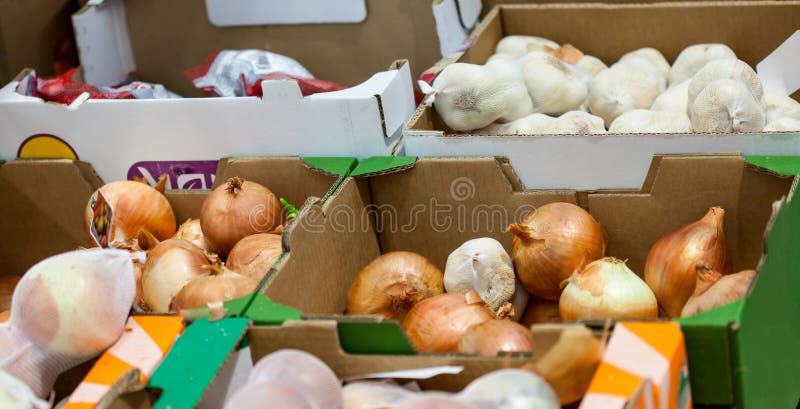 Onions and garlic in boxes stock image. Image of market - 163948887