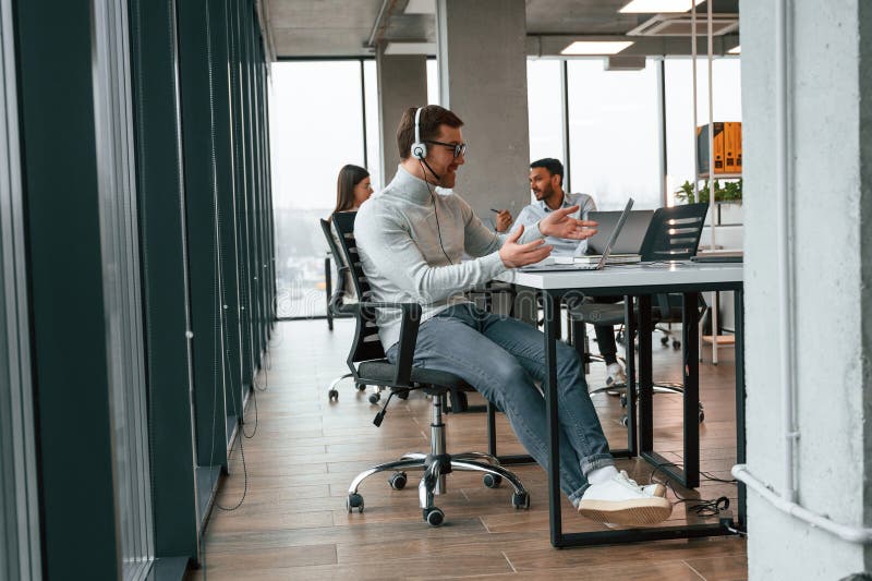 Online Conversation. Men and Woman are Working in the Office Together ...