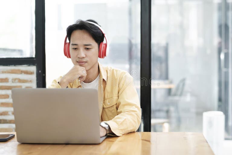 Young Collage Student Using Computer and Mobile Device Studying Online... Stock Image - Image of ...