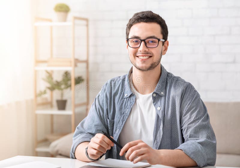 Online Home Study for Students. Smiling Guy with Glasses Sits at Table ...