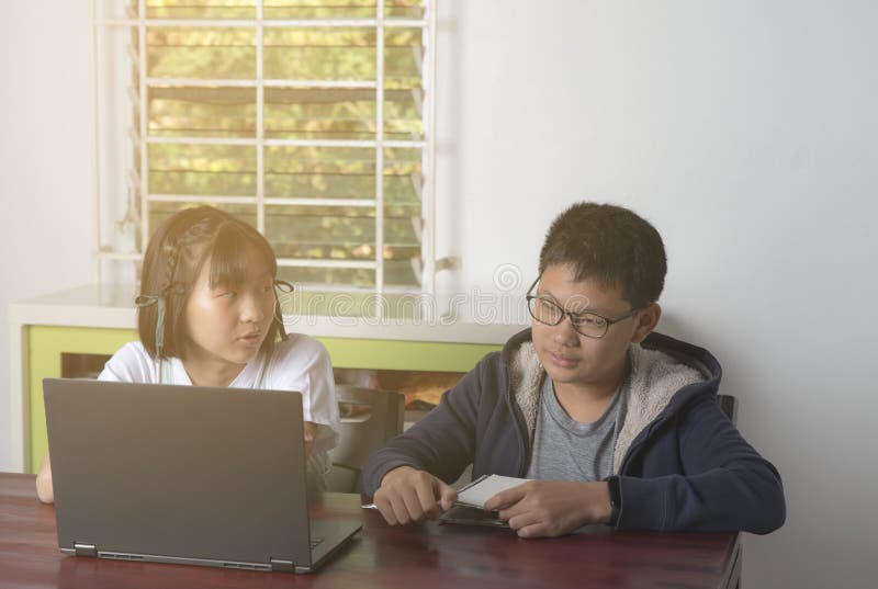 Asian Boys and Girls Sitting Studying Using Laptop Computer Stock Photo ...