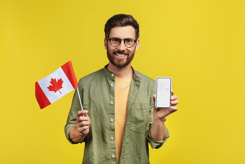 Online Learning Concept. Happy Man Holding Smartphone and Canada Flag ...