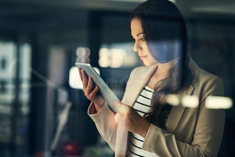 Online at Night Time. a Young Businesswoman Using a Digital Tablet ...