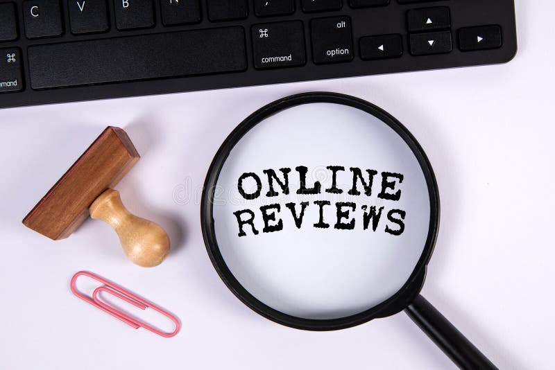 Online Reviews. Magnifying Glass and Computer Keyboard on White Office ...