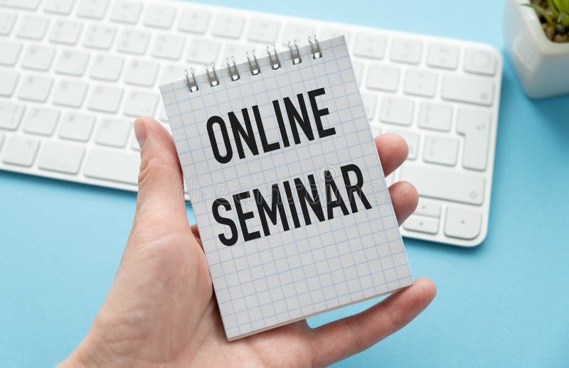 ONLINE SEMINAR Text on a Notebook in Hand, Folder on a Chart Background ...