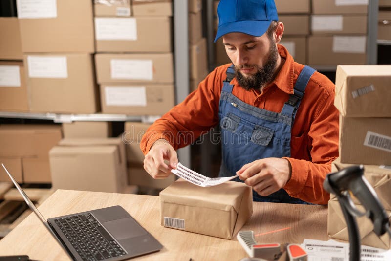 Online Store Owner Sticking a Barcode Label at the Package Box and ...
