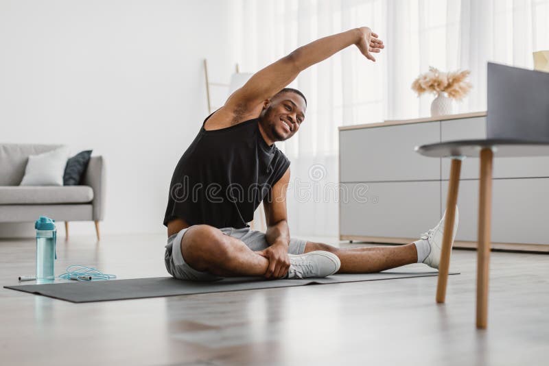 Cheerful Black Man Doing Side Bend Stretching Exercise at Home Stock ...