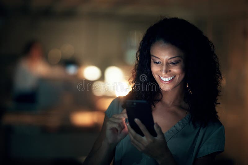 Online Whatever the Time. a Young Businesswoman Using a Mobile Phone ...