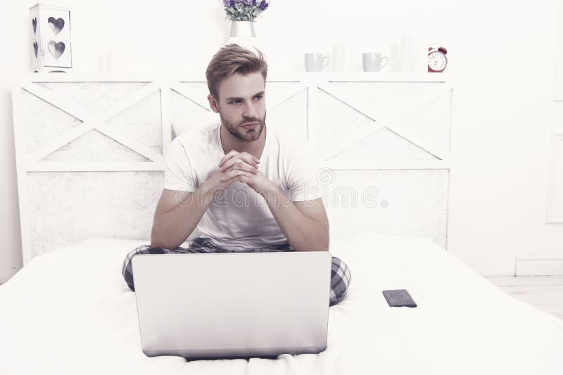 Online Work from Home Computer. Unshaven Man Use Laptop in Bed Stock ...