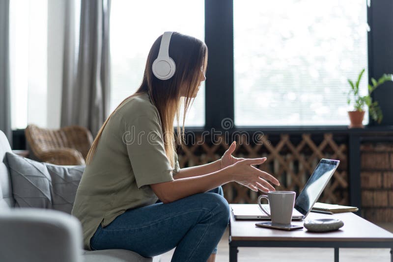 Online Work at Home. a Woman Using Laptop she Speaks with a Partner ...