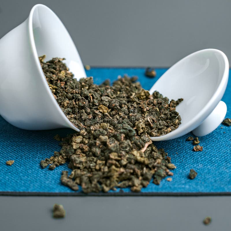 Oolong Tea Leaves are Elegantly Placed in White Cups on a Vibrant Blue ...