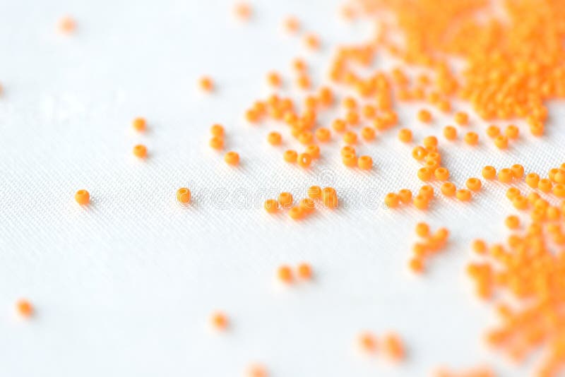 Opaque Seed Beads Orange Color Scattered on a Textile Background Stock ...