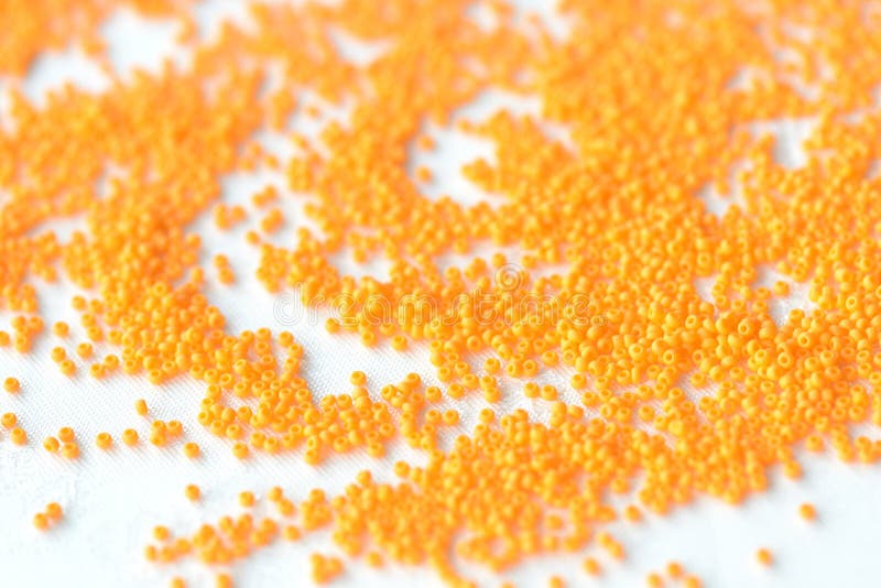 Opaque Seed Beads Orange Color Scattered on a Textile Background Stock ...