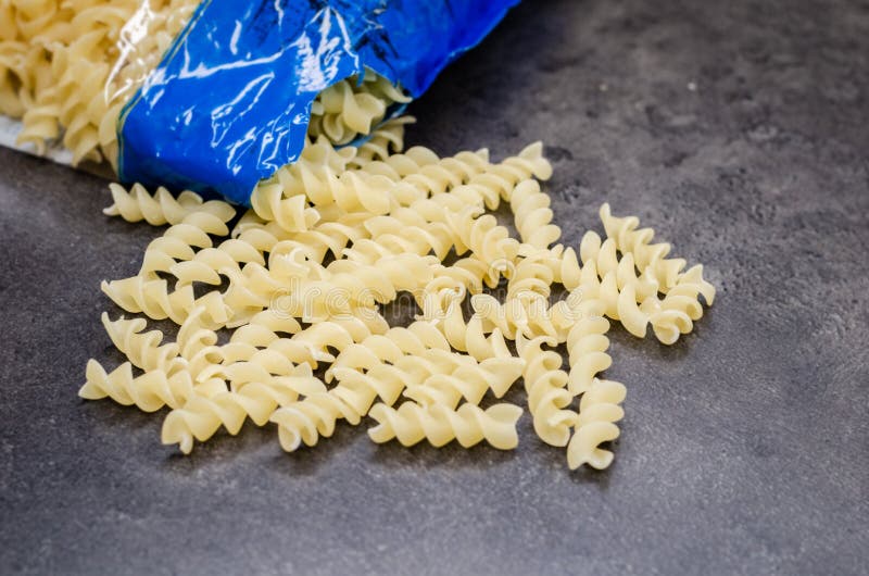Open Bag with Twisted Pasta on the Table Ready To Cook Stock Photo ...
