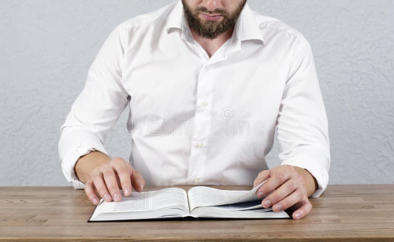 Open Bible Book on the Table. the Man in the Shirt. Book in Hand. Stock ...