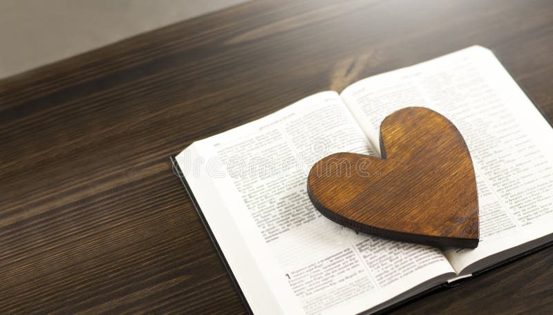 Open Bible Book on the Table. Wooden Heart. Book Love Concept Stock ...