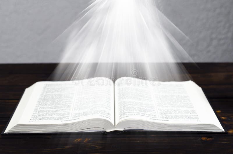 Open Bible, on a Wooden Table. Light from the Book. Desktop. Stock ...