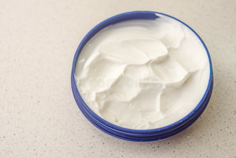 Open Blue Container with White Cream on a Marble Table Stock Image ...
