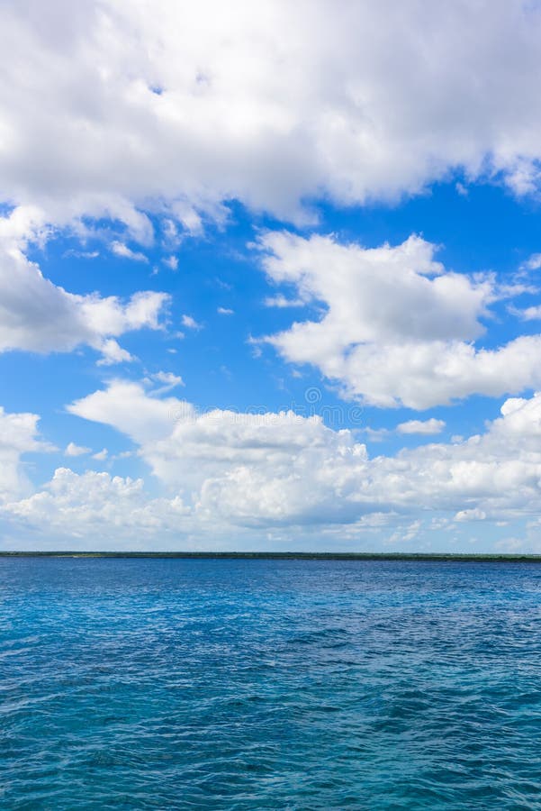 Open Blue Sea Cumulus Clouds Stock Photo - Image of scenic, reflection ...