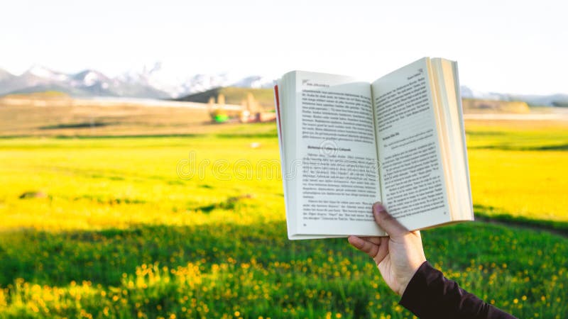 A Book Held in a Vibrant Spring Landscape, Symbolizing Learning and ...