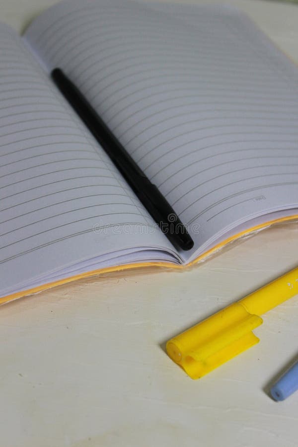 Open Book with Black Lines with Colorful Pencils on a White Table Stock ...