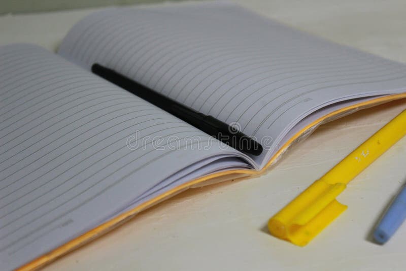 Open Book with Black Lines with Colorful Pencils on a White Table Stock ...
