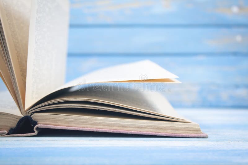 Open Book on Blue Wooden Background Stock Image - Image of background ...