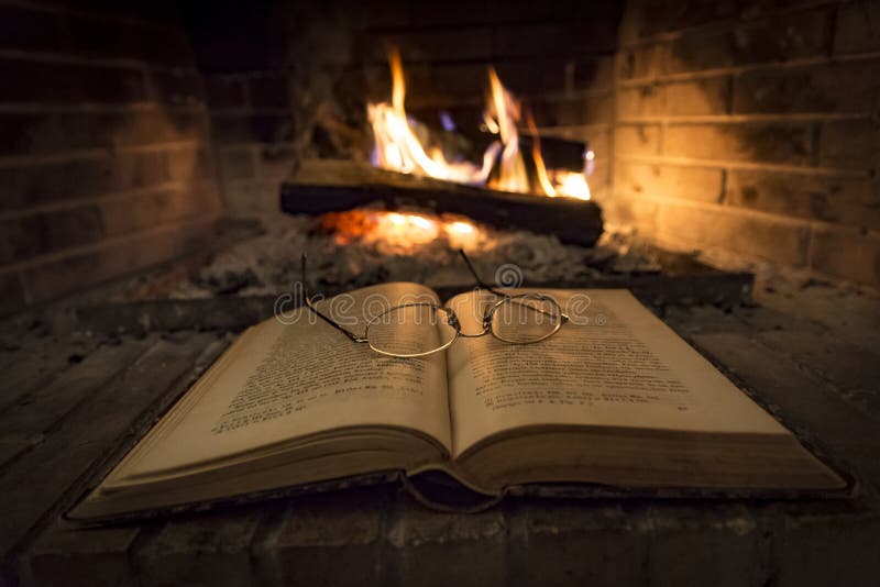 Open Book beside Burning Fireplace Stock Photo - Image of eyeglasses ...