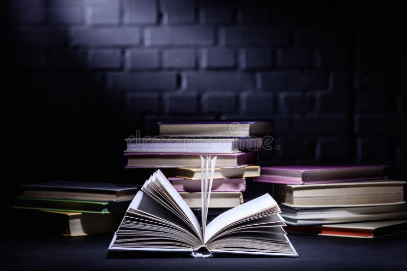 Open Book in Front of Stack of Books Stock Image - Image of table ...