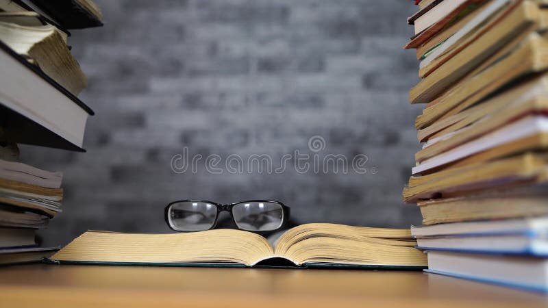 Open Book and Glasses on Desk in Office or Library. Learning Concepts ...