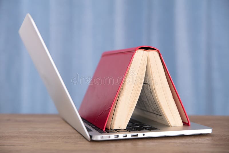 An Open Book on the Laptop Keyboard Stock Image - Image of book, remote ...