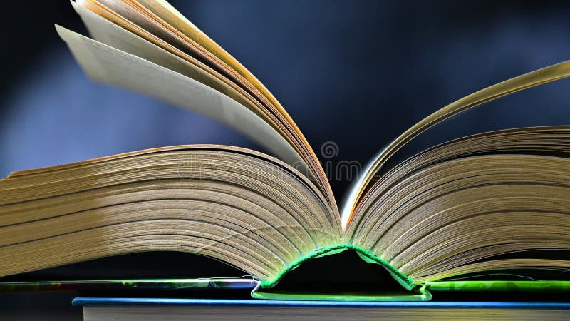An Open Book Lying on a Stack of Other Books Stock Video - Video of ...
