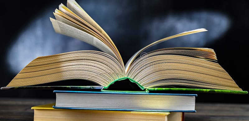 An Open Book Lying on a Stack of Other Books Stock Image - Image of ...