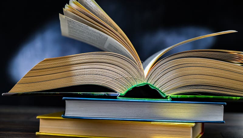 An Open Book Lying on a Stack of Other Books Stock Image - Image of ...