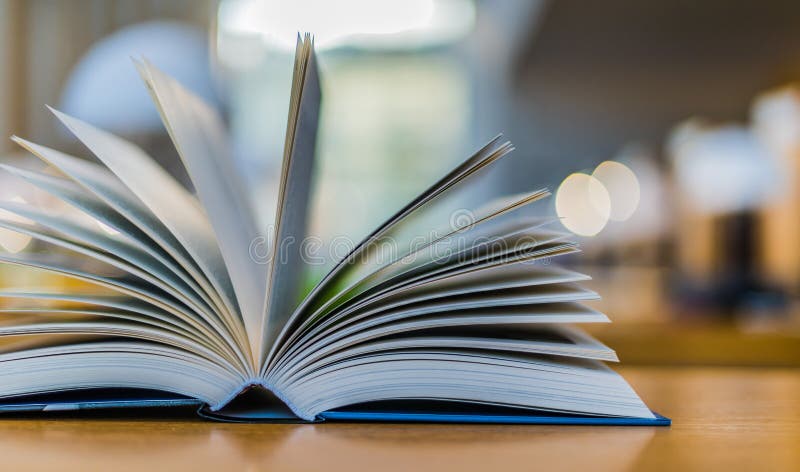 Open Book Lying on the Table in the Library Stock Photo - Image of ...