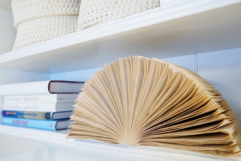 Open Book with Pages Lying on White Bookshelf Stock Image - Image of ...