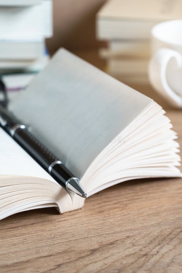 Open Book with Pen on Wooden Table Stock Image - Image of book, wood ...