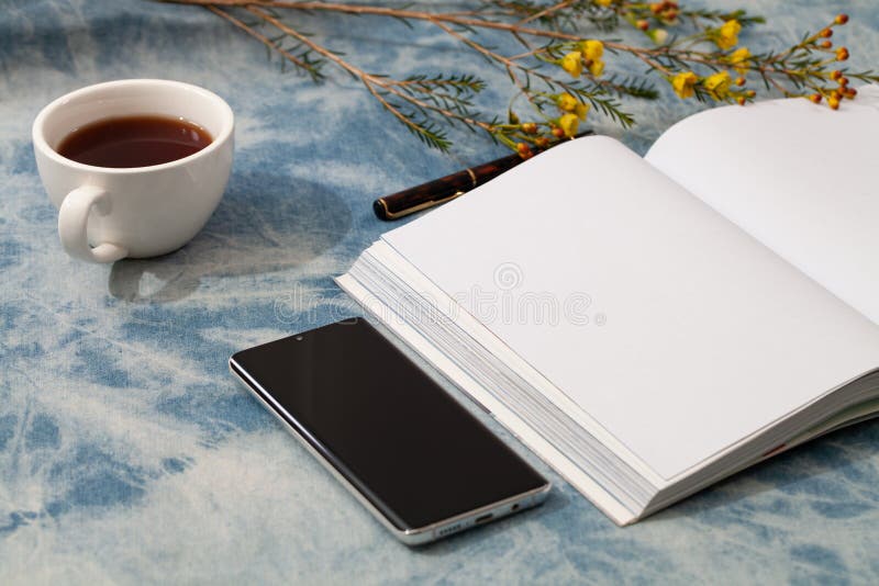Open Book, Phone and Pen on the Blue Cloth Stock Photo - Image of ...
