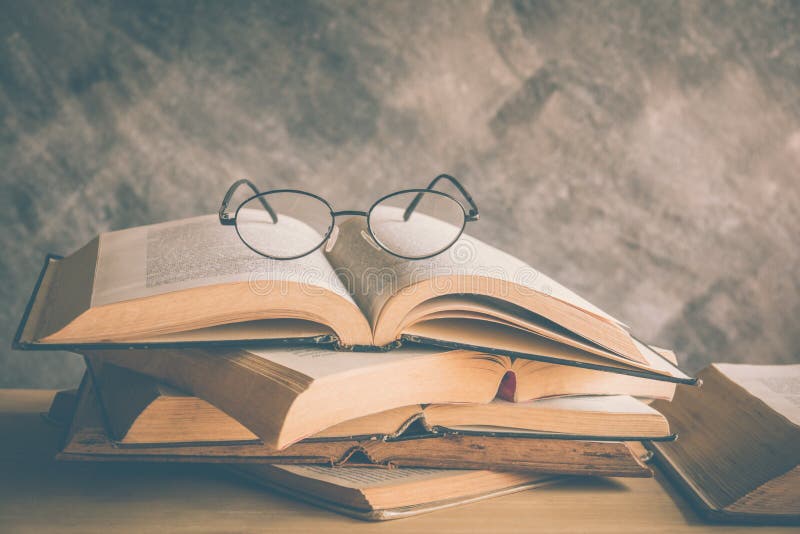 Open Book with Reading Glasses in the Bookshelf Stock Photo - Image of ...