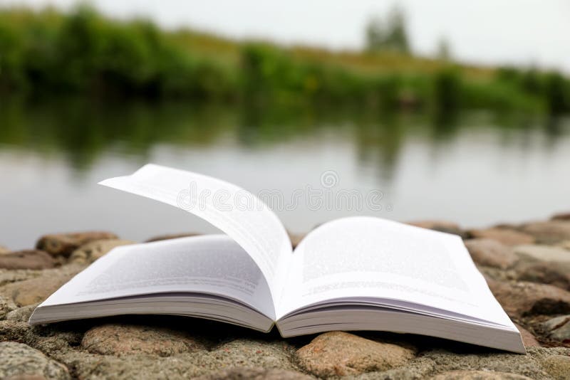 Open Book on Rocky Shore Near River Stock Photo - Image of plot ...