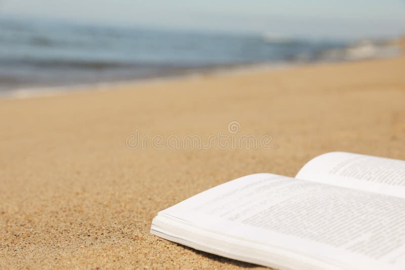 Open Book on Sandy Beach Near Sea, Closeup. Space for Text Stock Image ...