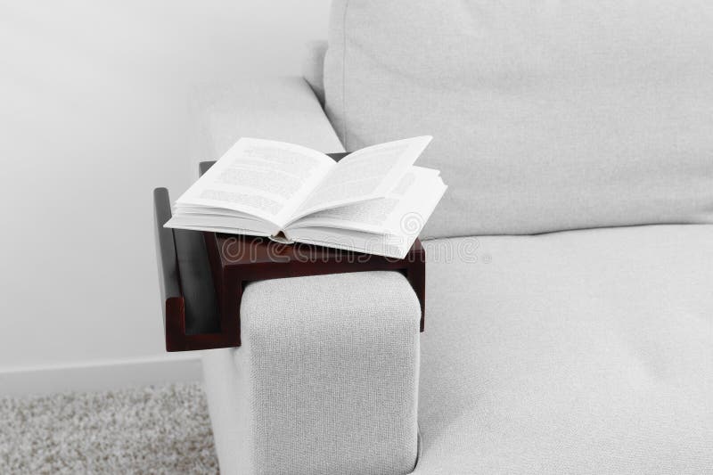 Open Book on Sofa with Wooden Armrest Table Indoors. Interior Element ...