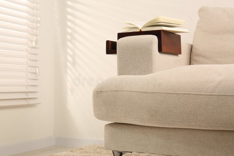 Open Book on Sofa with Wooden Armrest Table in Room, Space for Text ...