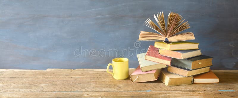 Open Book on a Stack of Books and a Cup of Coffee. Reading, Learning ...