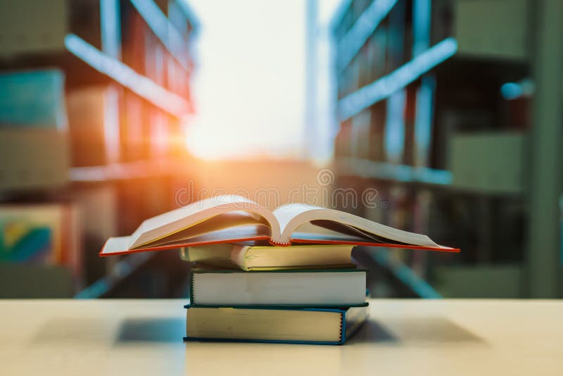 Open Book on Stack of Books in Library at School, University, College ...